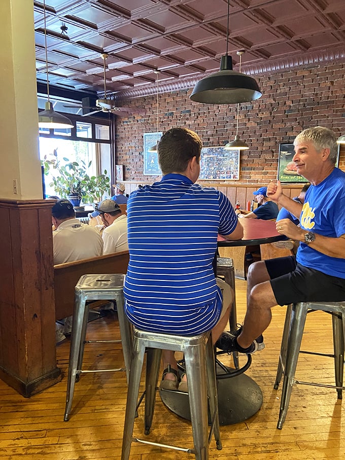 Where strangers become friends over shared cheesesteak appreciation. Notice the Pitt gear—sandwich loyalty runs second only to sports loyalty here.