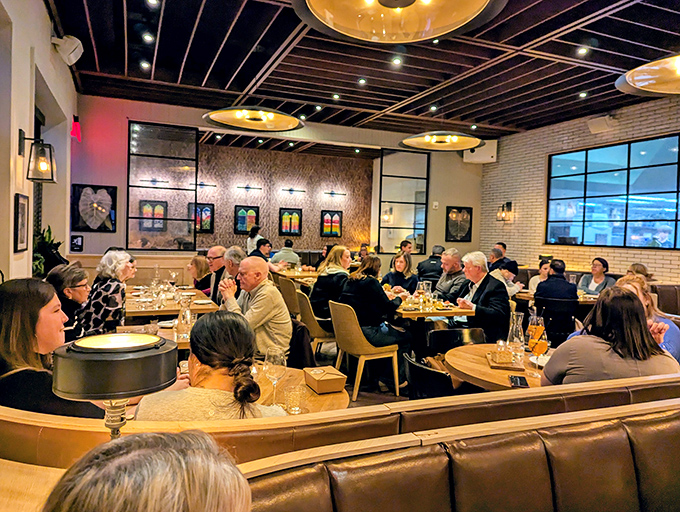 Diners lean in over plates of pasta, sharing bites and stories—the universal language of good food bringing strangers together.