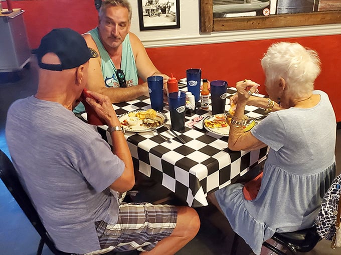 Three generations sharing breakfast and conversation—the true magic of places like Mrs. Mac's where food brings people together.