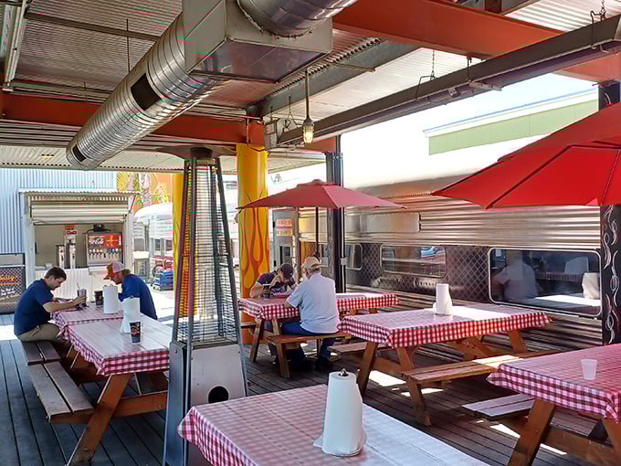 The outdoor dining area proves that picnic tables and checkered tablecloths are the natural habitat for proper BBQ consumption—as nature intended.