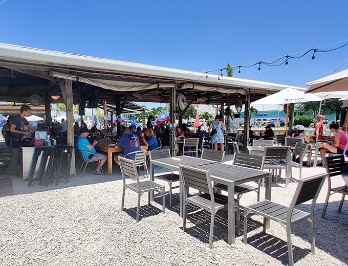 Where locals and tourists find common ground—under umbrellas, over cold drinks, with the universal language of "pass the hot sauce" bringing everyone together.