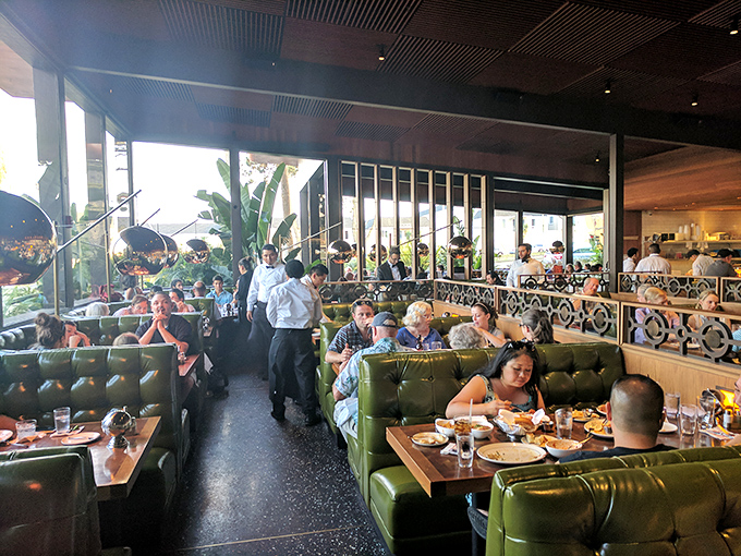 A bustling dining room where conversations flow as freely as the wine—these green booths have heard decades of first dates and family celebrations.