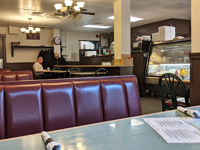 Red vinyl booths that have cradled countless conversations, from first dates to retirement plans and everything in between.