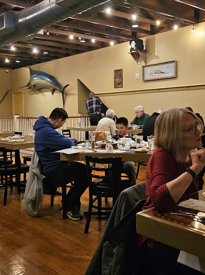 Mounted marlins and nautical wheels aren't just décor—they're silent witnesses to decades of seafood celebrations and butter-dipped memories.
