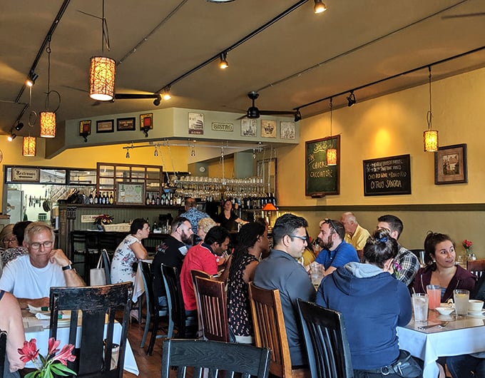 A bustling dining room filled with happy eaters—the universal language of good food bringing strangers together under one delicious roof.