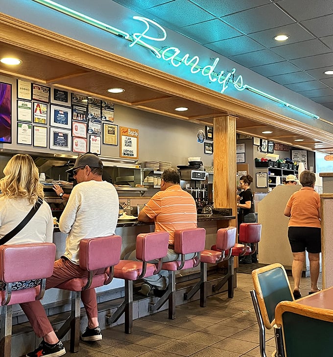 The counter seating—where solo diners become regulars and the staff eventually knows your order before you sit down.