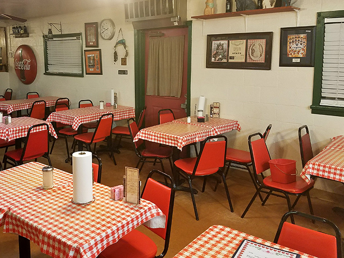The dining area feels like a community living room where strangers become friends over plates of comfort food and red-checkered memories.