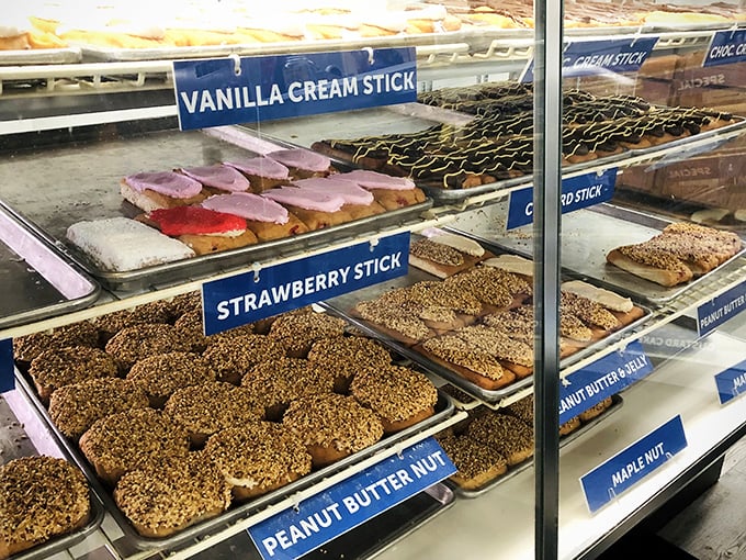 The donut case offers a United Nations of pastry options—from vanilla cream sticks to peanut butter treats that demand your respect.