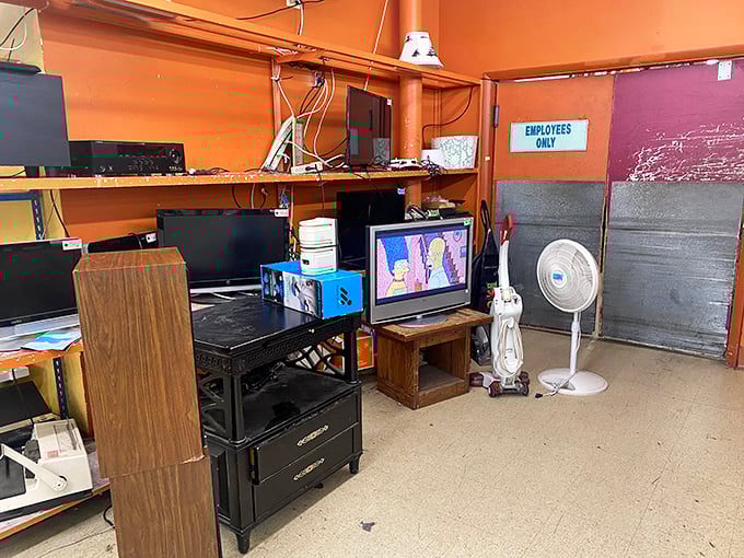 The electronics corner looks like Mission Control circa 1995, where yesterday's cutting-edge technology awaits your nostalgic embrace.