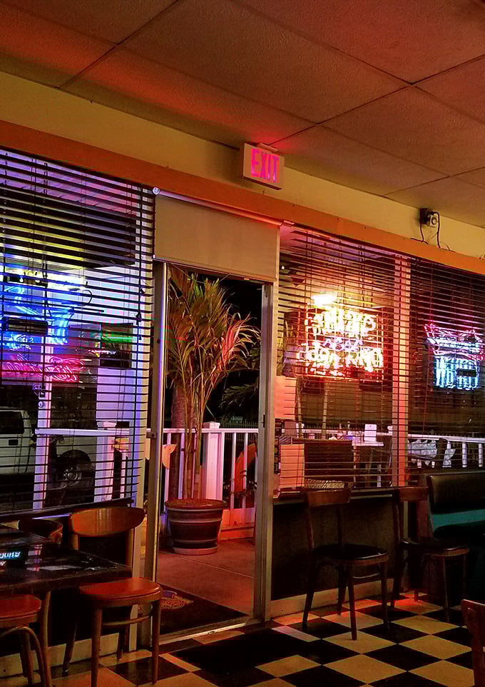 When neon lights meet Florida nights, magic happens. That palm plant standing sentry by the door is the perfect tropical doorman. 
