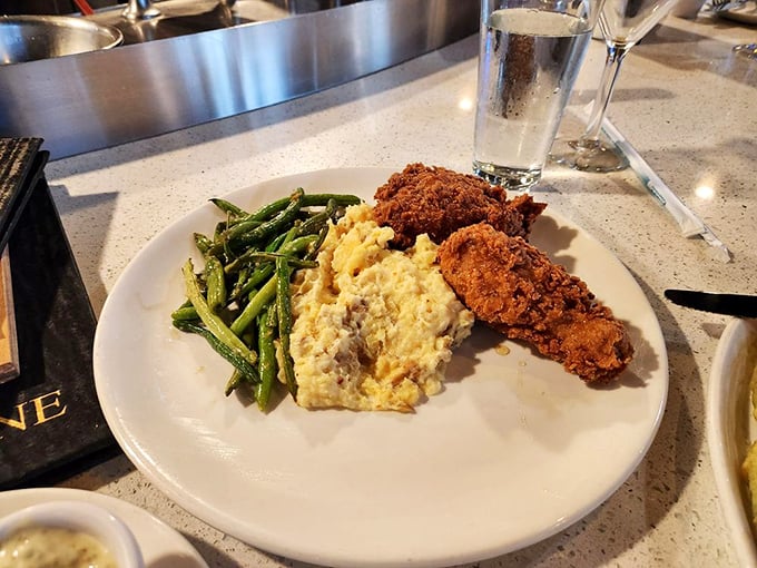 Fried chicken so golden and glorious, it might make you temporarily forget you came for seafood—that honey drizzle is pure genius.