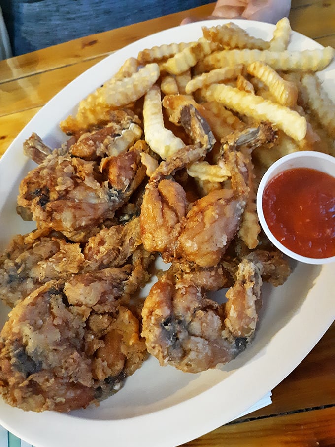 Crispy fried frog legs with perfectly golden fries—proof that sometimes the most unexpected menu items deliver the most memorable meals. Tastes like chicken? Only better.
