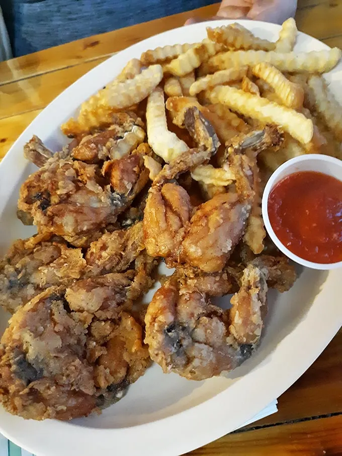 Crispy fried frog legs with perfectly golden fries—proof that sometimes the most unexpected menu items deliver the most memorable meals. Tastes like chicken? Only better.