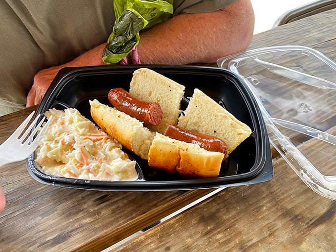 Sometimes simplicity wins—a perfectly smoked sausage nestled in a soft bun with coleslaw on the side. No frills, just thrills.