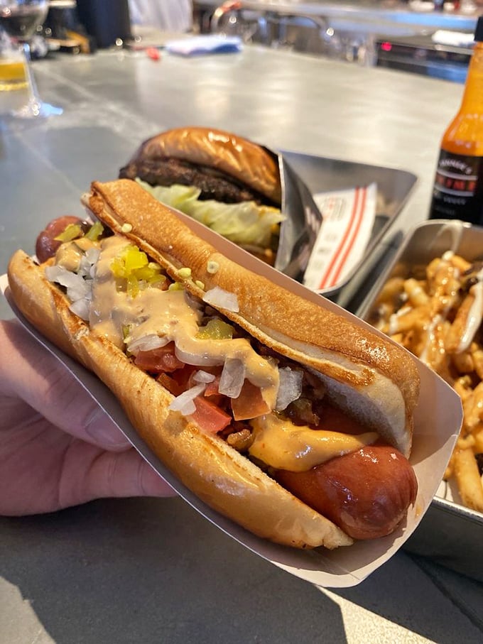This isn't just a hot dog—it's a beef hot dog elevated to gourmet status with toppings that make ketchup and mustard seem like distant relatives.