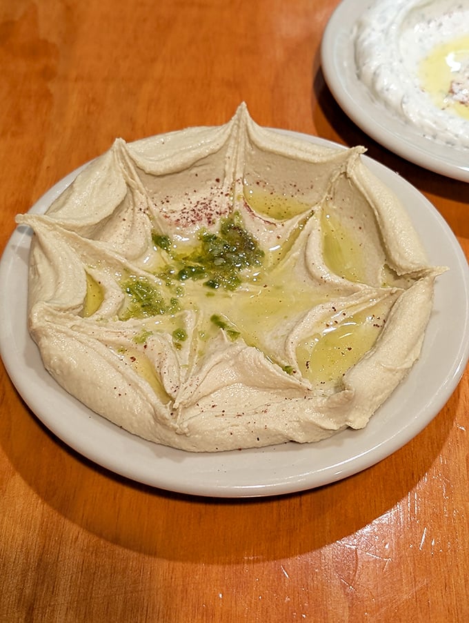 Hummus shouldn't just be a dip—it should be an experience. This artfully presented version, with its moat of olive oil, is ready for your bread-wielding invasion.