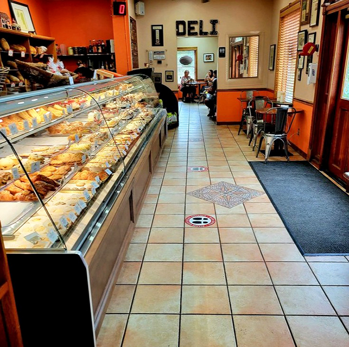 The display case stretches like a runway of carbs, each pastry more photogenic than the last—the supermodels of the baking world.