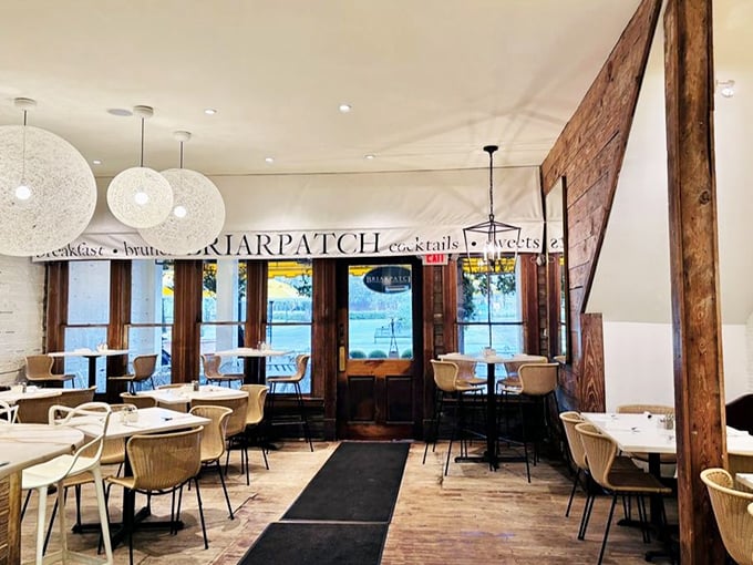 Rustic wooden beams meet elegant white walls—a dining room that feels like it's giving you a warm hug before the food even arrives.