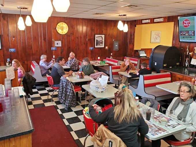 Red booths frame conversations that have been ongoing for decades—some political debates here are older than certain senators.