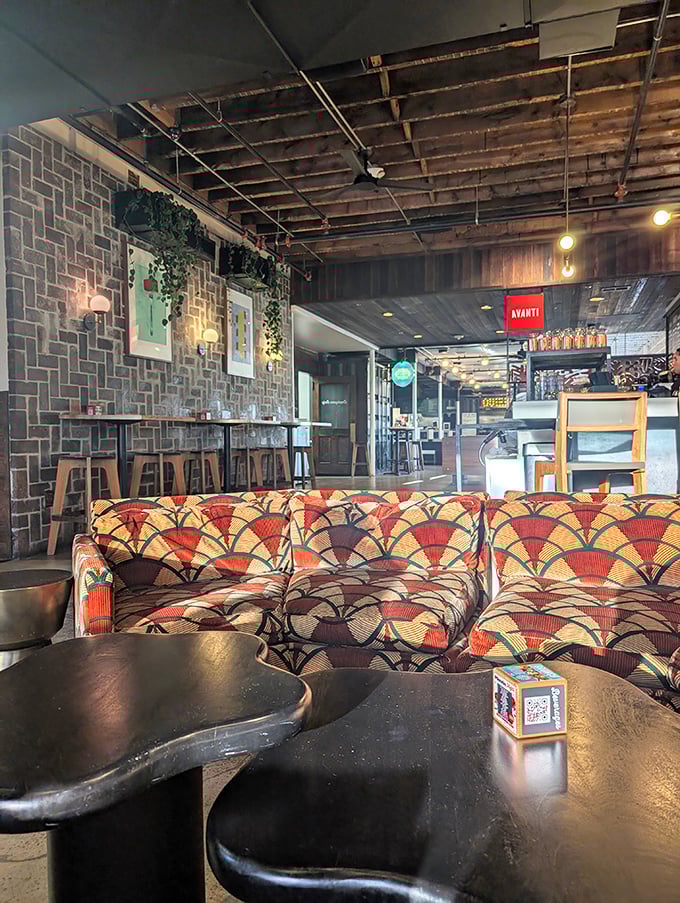 That retro-fabulous couch isn't just seating—it's a time machine to the era when conversation and comfort were the ultimate dining companions.