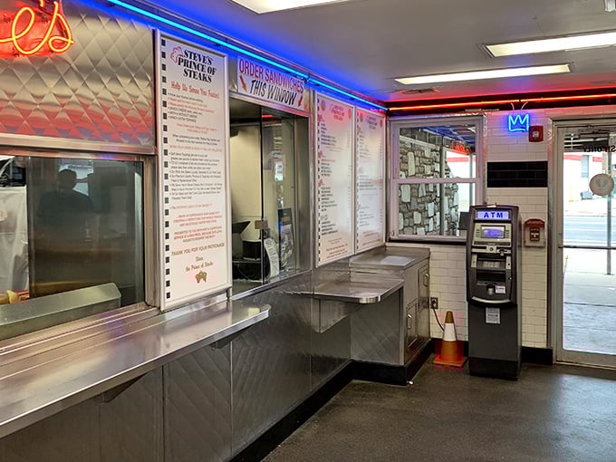 The ordering counter glows like the gates of paradise, with neon signage guiding hungry souls to salvation.