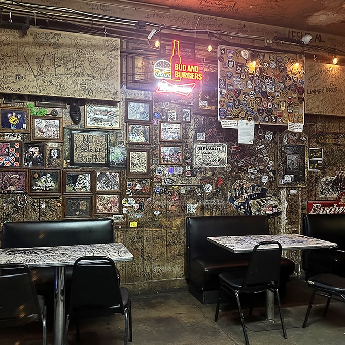 Every inch of wall space tells a story at Adair's, where the "Bud and Burgers" sign isn't just advertising—it's a perfect two-word mission statement.