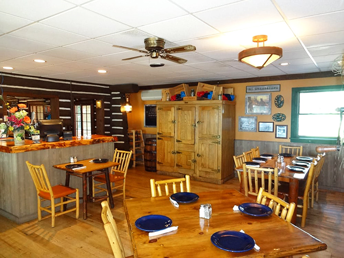The dining room feels like the cabin you wish your family owned—warm wood tones, blue plates, and the promise of comfort food.