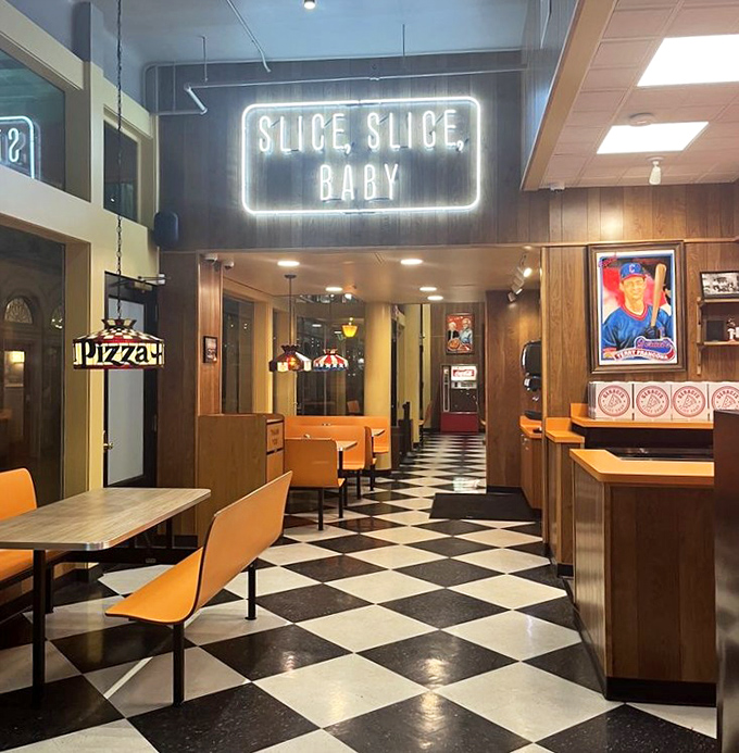 Classic checkered floors and wood-paneled walls create that timeless pizzeria vibe where memories are made one slice at a time.