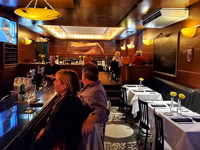 The bar area balances old-school charm with modern comfort—like if Frank Sinatra designed a living room for friends.