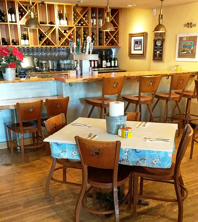 The bar area combines coastal charm with California wine country sensibility. That "FISH STORIES TOLD HERE" sign isn't kidding around.