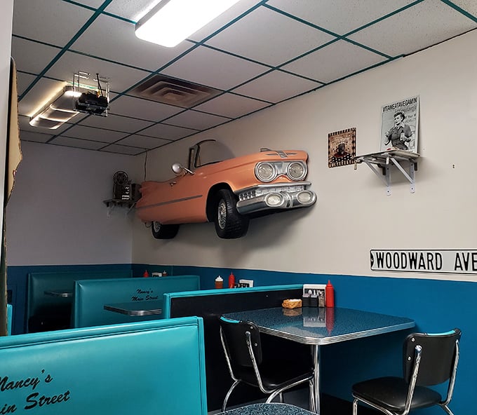 That vintage car mounted on the wall isn't just decor—it's a conversation starter. Woodward Ave sign completes the time capsule that is Nancy's dining room.