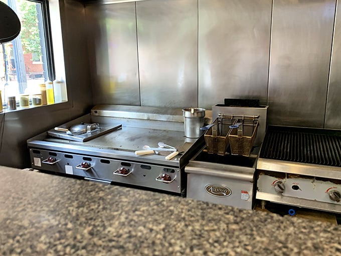 The well-seasoned flat-top grill—where cheesesteak magic happens daily. Those aren't just cooking surfaces; they're flavor-building platforms.