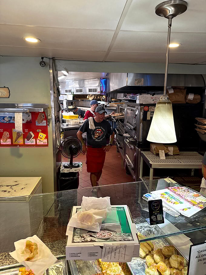 A glimpse into the kitchen reveals the behind-the-scenes magic where dough is transformed into the pizzas that inspire cross-state pilgrimages.