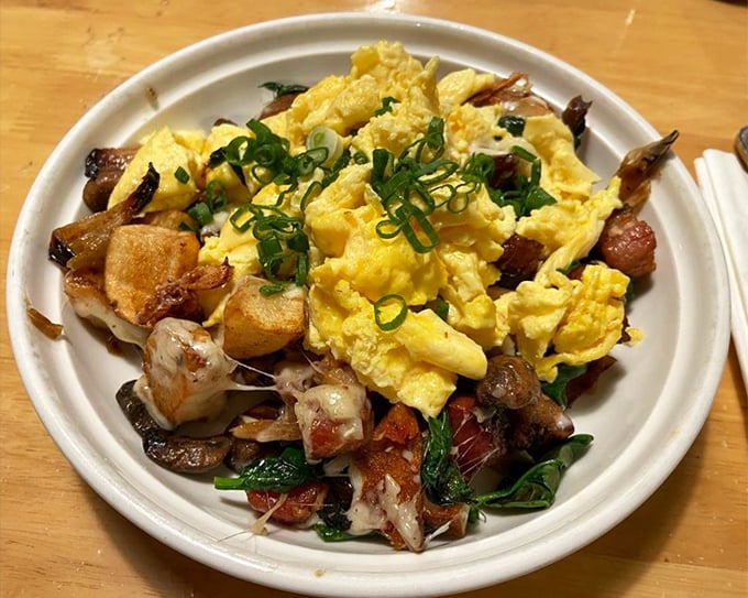 The aptly named "Kitchen Sink" dish—scrambled eggs nestled among potatoes, bacon, and greens. Breakfast architecture that somehow manages to be both rustic and refined.