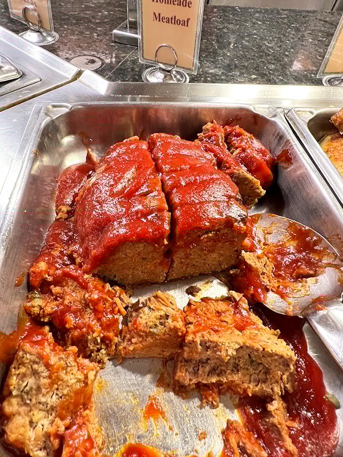Homemade meatloaf under a blanket of tangy sauce—comfort food that transports you straight to Sunday dinner at your favorite aunt's house.