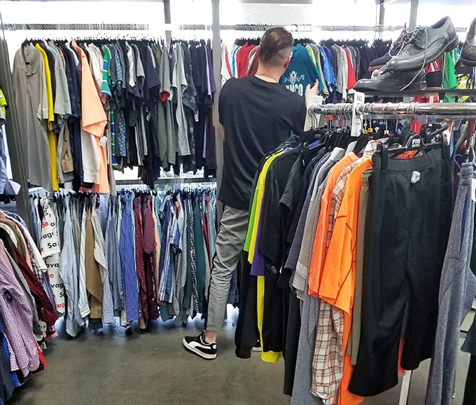 Men's section browsing in progress – proof that savvy style isn't just for the ladies. Those designer button-downs won't last long at these prices.