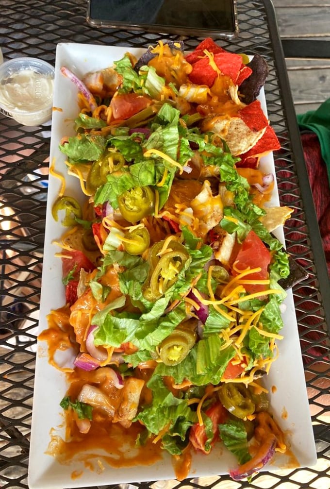 Nachos that refuse to be a mere appetizer. This colorful mountain of deliciousness demands respect—and extra napkins.
