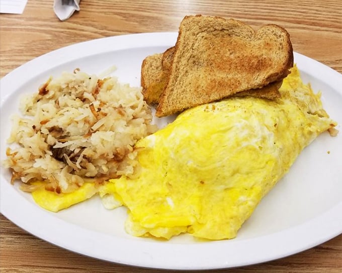 An omelet that's achieved the impossible balance – substantial yet fluffy, with hash browns crisped to golden perfection. Breakfast engineering at its finest.