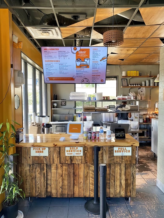 The ordering counter—where dreams become reality. Simple signage and wooden panels say, "We're serious about biscuits, not about pretension."