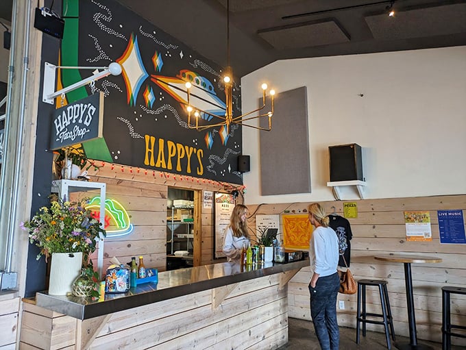 Happy's Taco Shop brings vibrant energy with its colorful mural and wooden counter—proof that serious food can come from playful places.