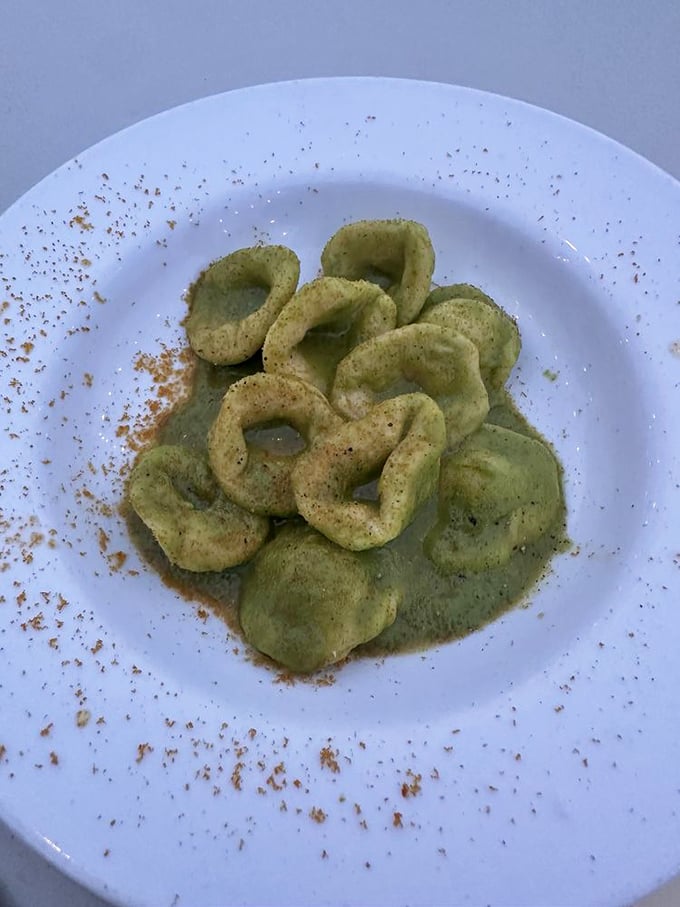 These green orecchiette ("little ears" of pasta) listen carefully to their dusting of spice, whispering promises of Sicilian comfort with every bite.