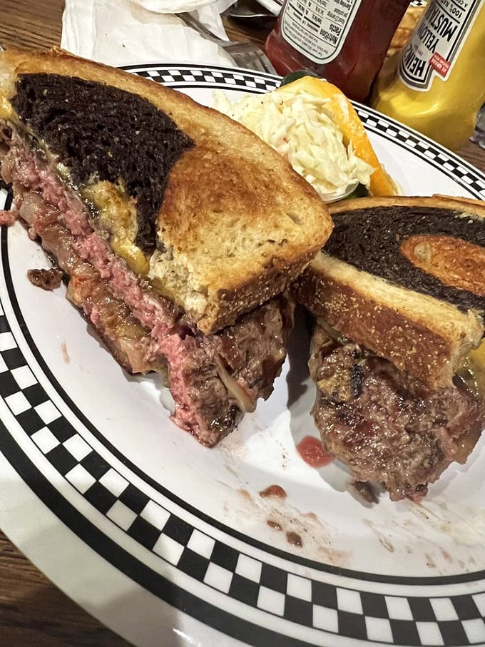 This patty melt isn't just cooked—it's been sweet-talked into melty, beefy submission between two slices of grilled rye bread. Pure comfort on a plate.
