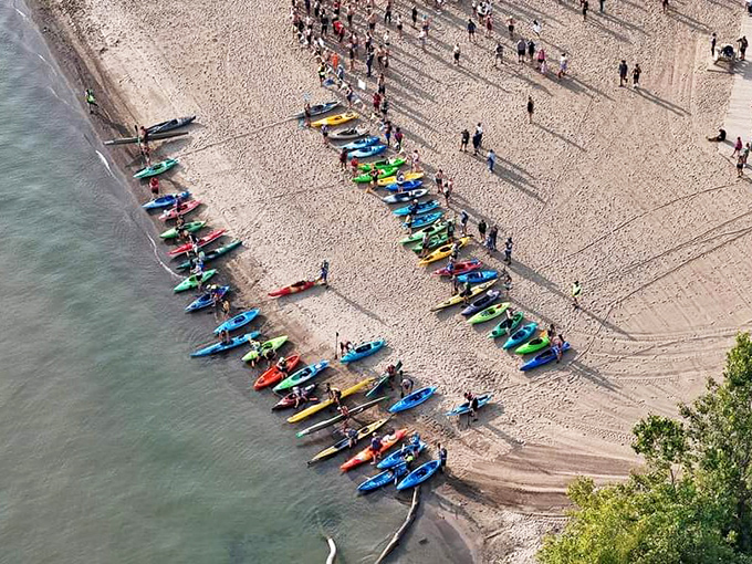 A colorful armada of kayaks lines the shore during Fairport Harbor's water events, transforming the beach into a vibrant celebration of outdoor adventure.