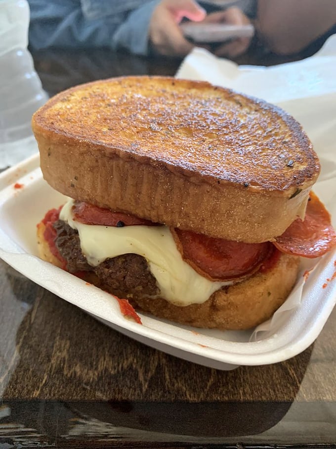 The Pizza Burger performs culinary diplomacy, bringing together two comfort food superpowers in one handheld summit of flavor that somehow works brilliantly.