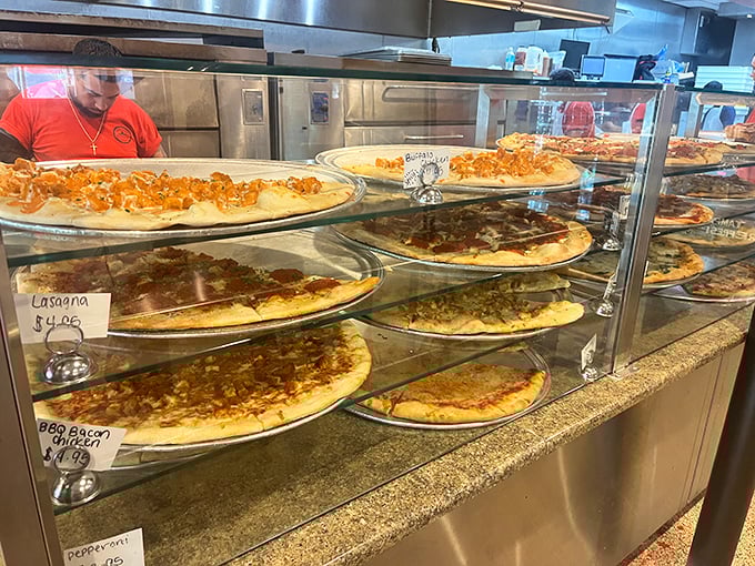 Pizza paradise on display – each pie patiently waiting its turn to become someone's best decision of the day.