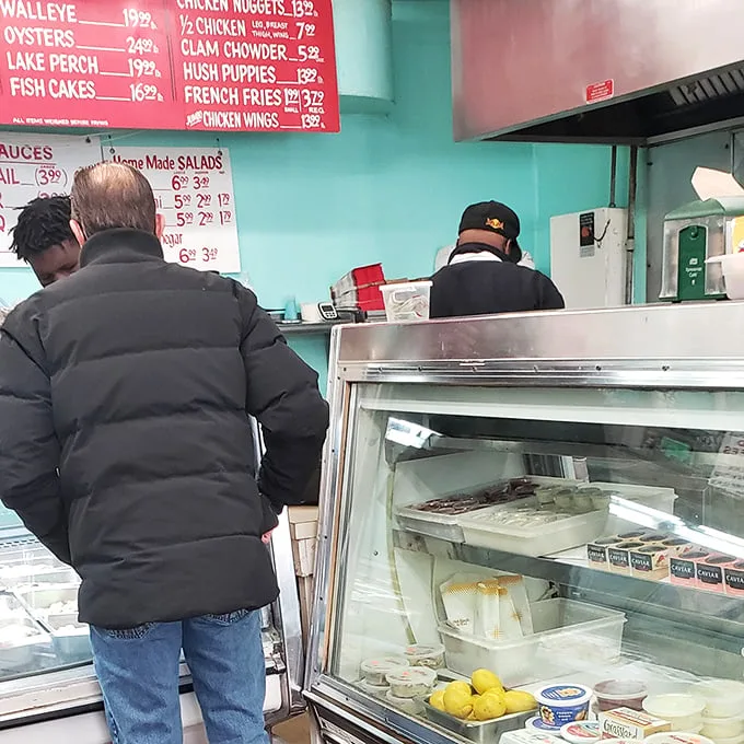 The time-honored ritual of placing an order at The Fish Keg – where patience is always rewarded with seafood perfection.