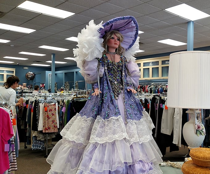 This lavender-clad doll with her feathered hat isn't just decorative—she's judging your outfit choices from her perch near the entrance.