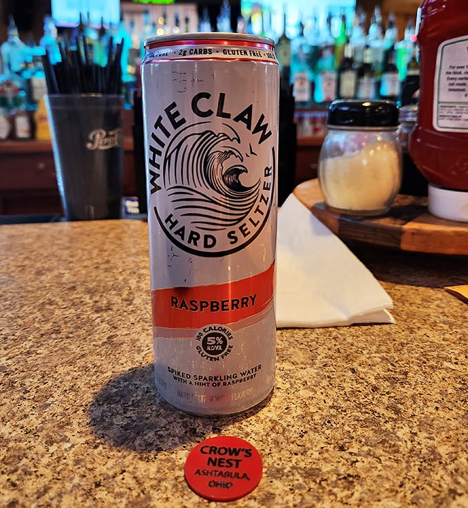 Even the beverages get special treatment here, with White Claw sitting atop the bar alongside a custom coaster—because details matter in hospitality.
