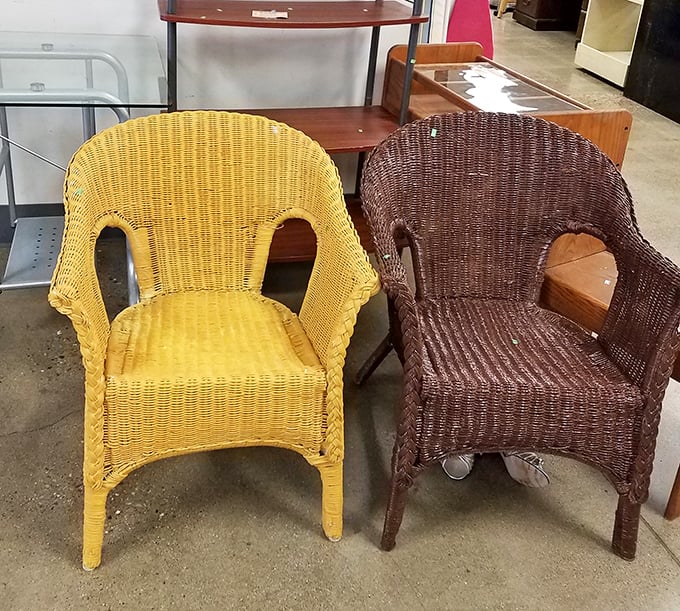 The wicker chair twins – one sunshine yellow, one chocolate brown – waiting for someone to give them the porch life they deserve.
