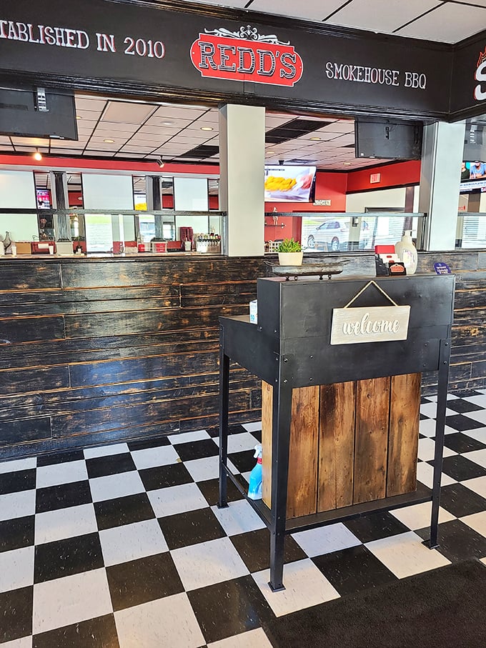 The reception area blends rustic charm with practicality – that checkerboard floor has seen many happy BBQ pilgrims come and go.